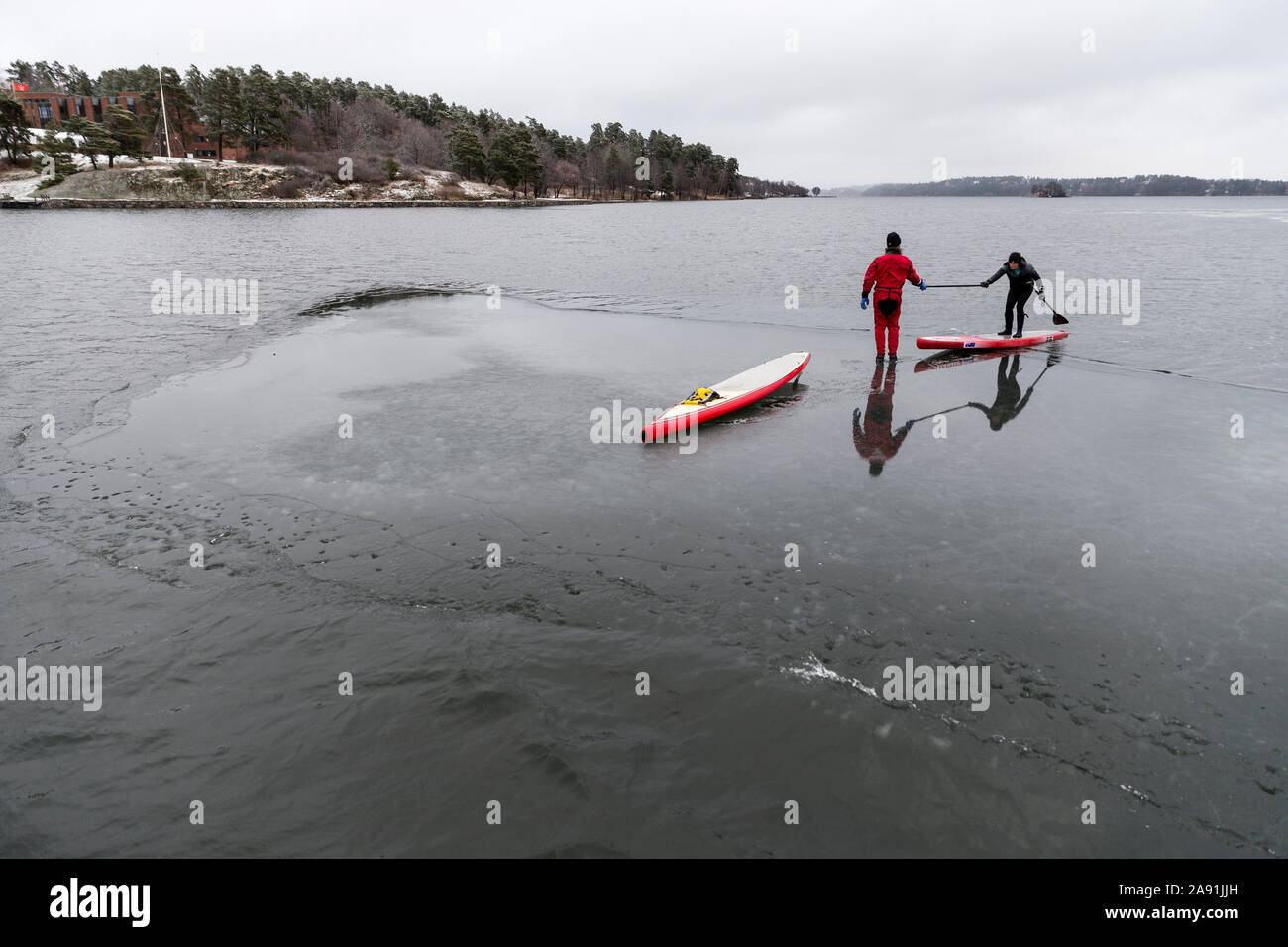 Man and woman paddle boarding Stock Photo - Alamy