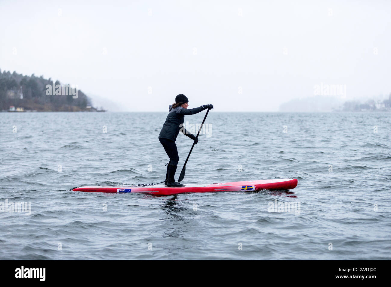 Woman paddle boarding Stock Photo - Alamy