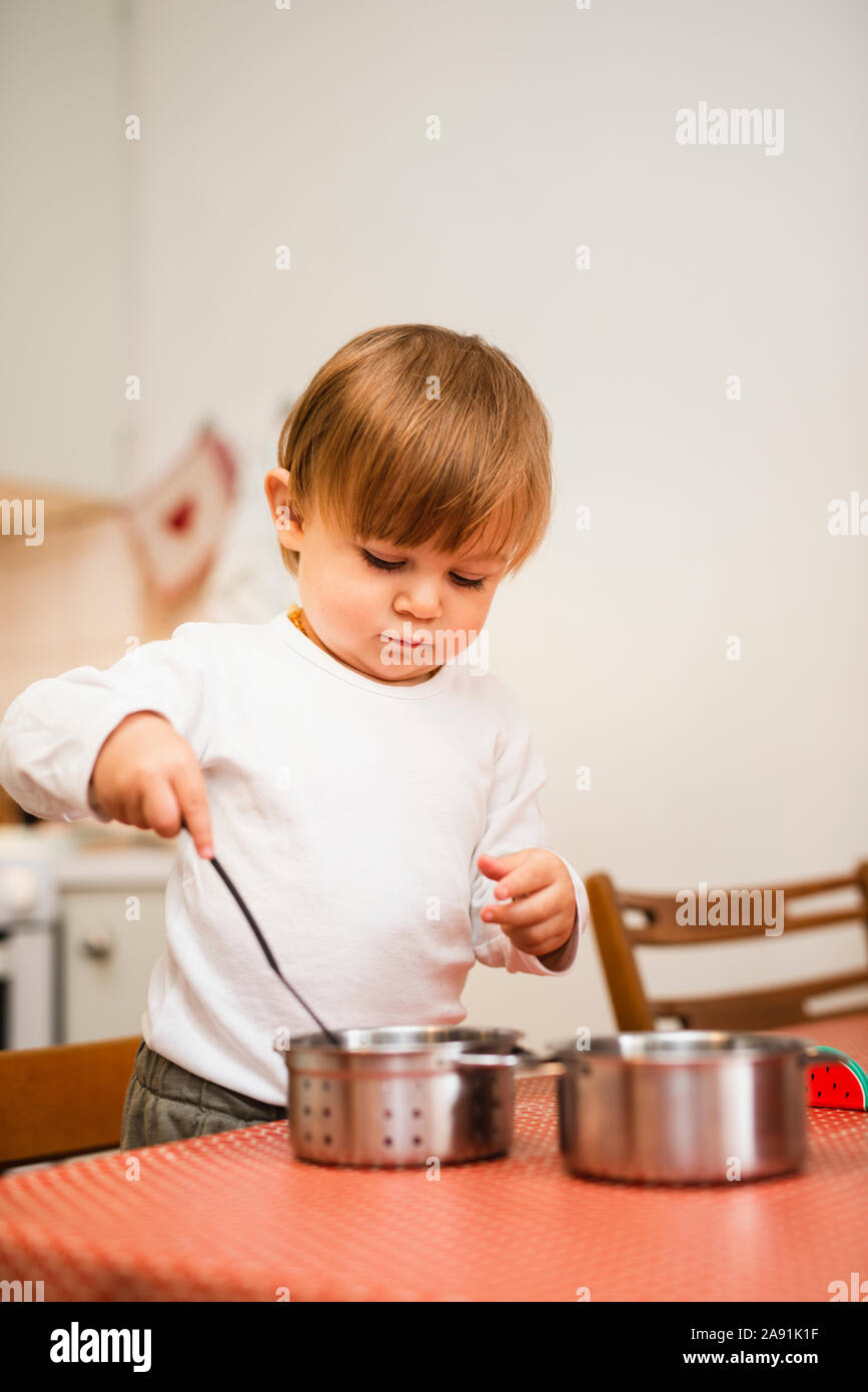 Boy playing with pots Stock Photo - Alamy
