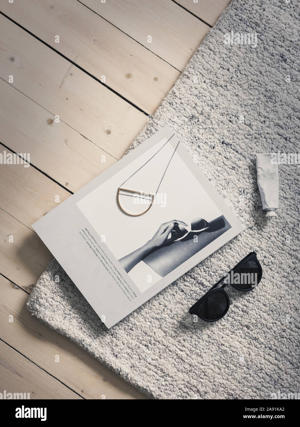 Magazine and sunglasses on carpet Stock Photo - Alamy
