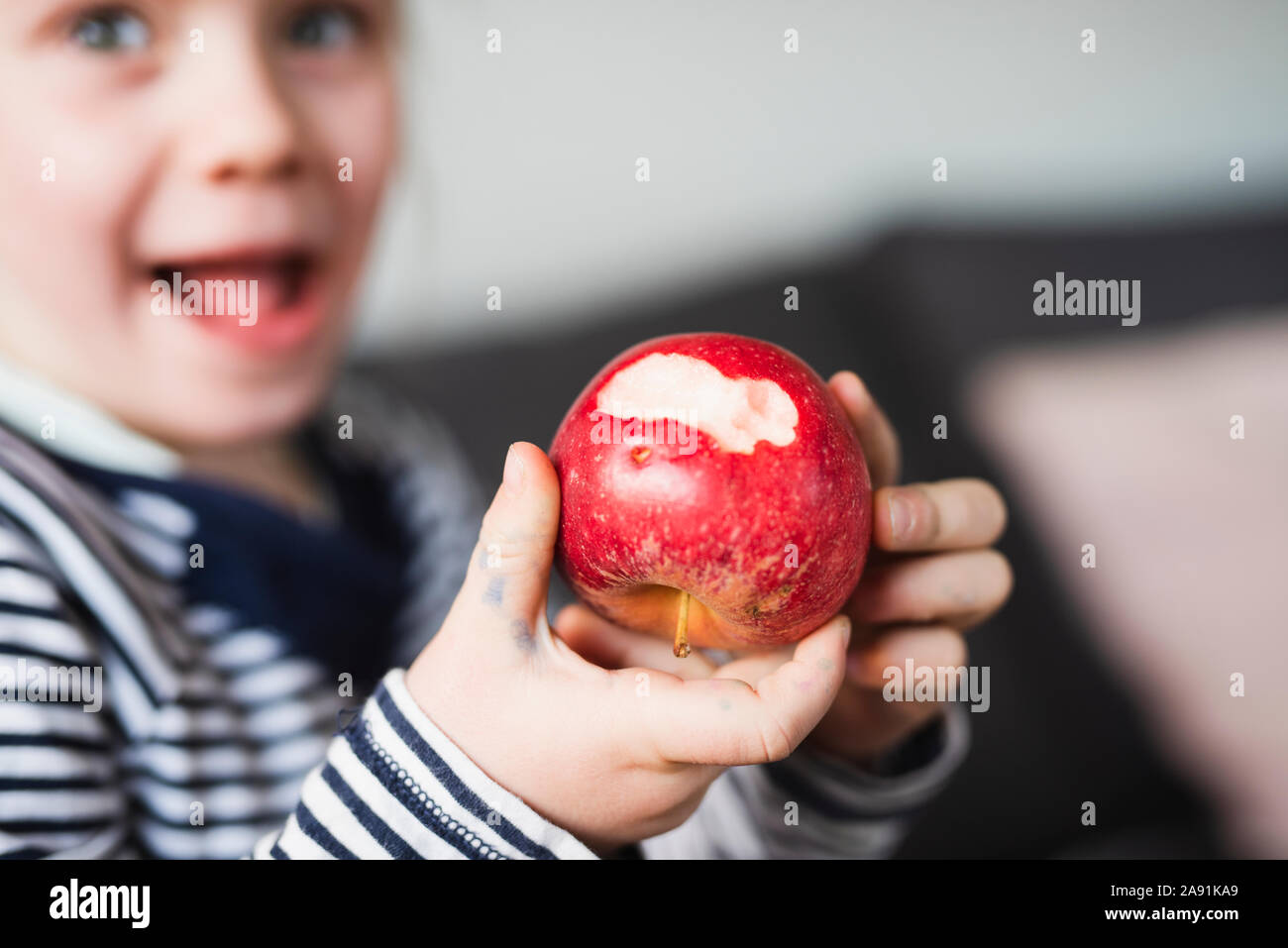 Girl holding apple Stock Photo - Alamy