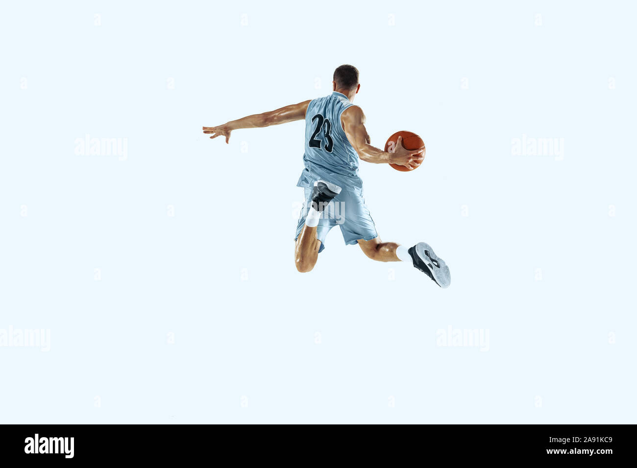 High flight. Young caucasian basketball player of team in action ...