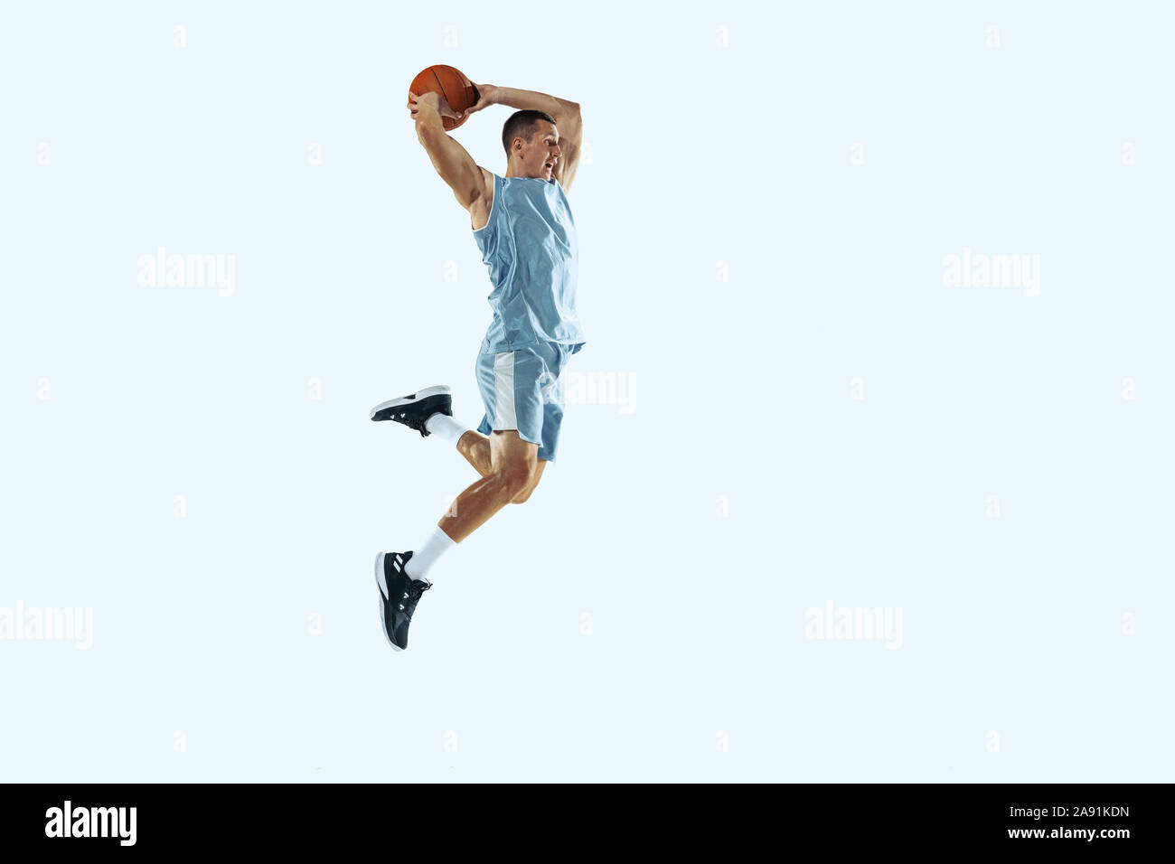 High flight. Young caucasian basketball player of team in action ...