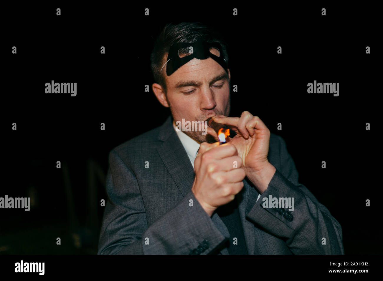 Man smoking cigar at party Stock Photo - Alamy
