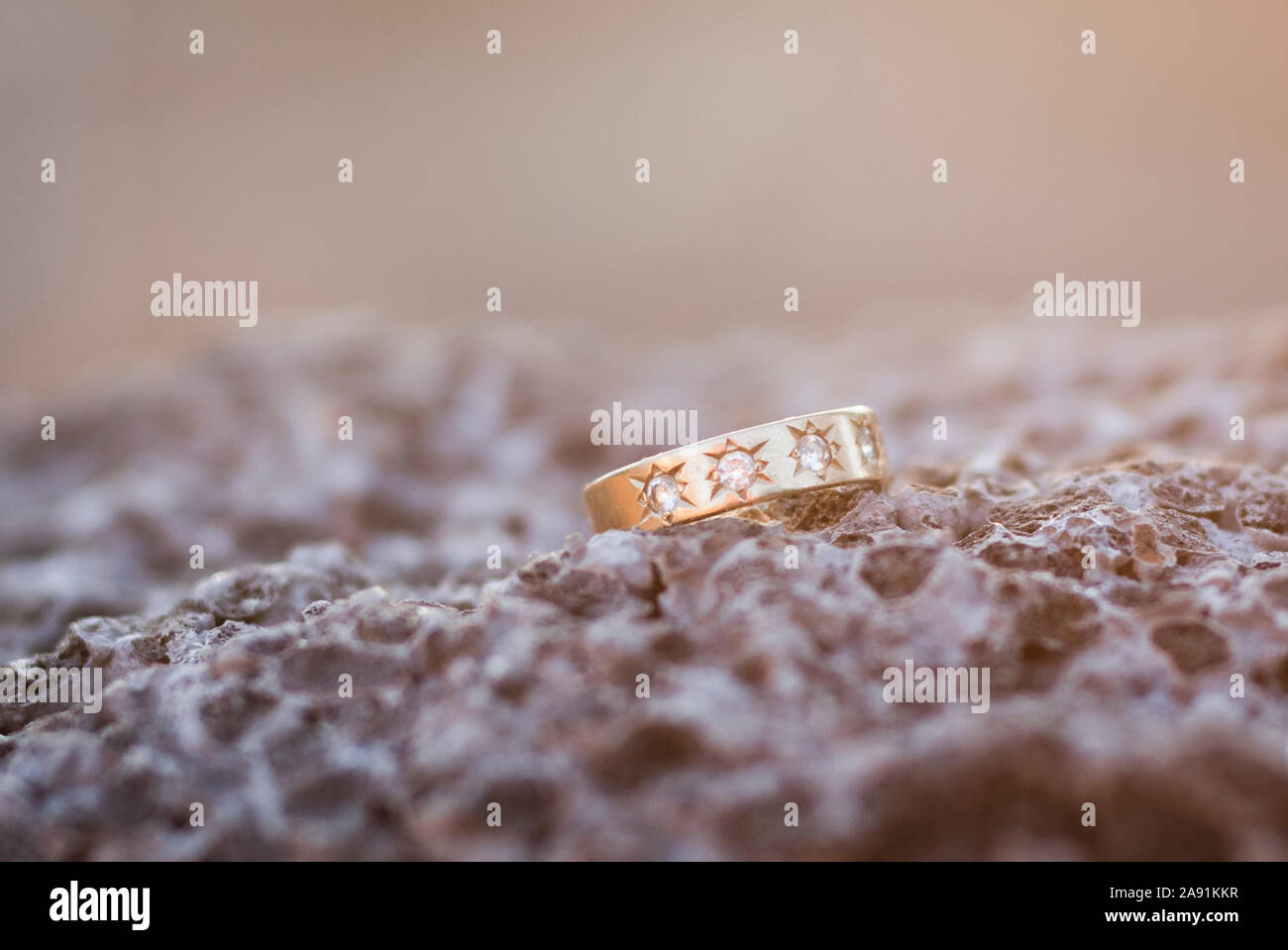 Wedding ring on rock Stock Photo - Alamy