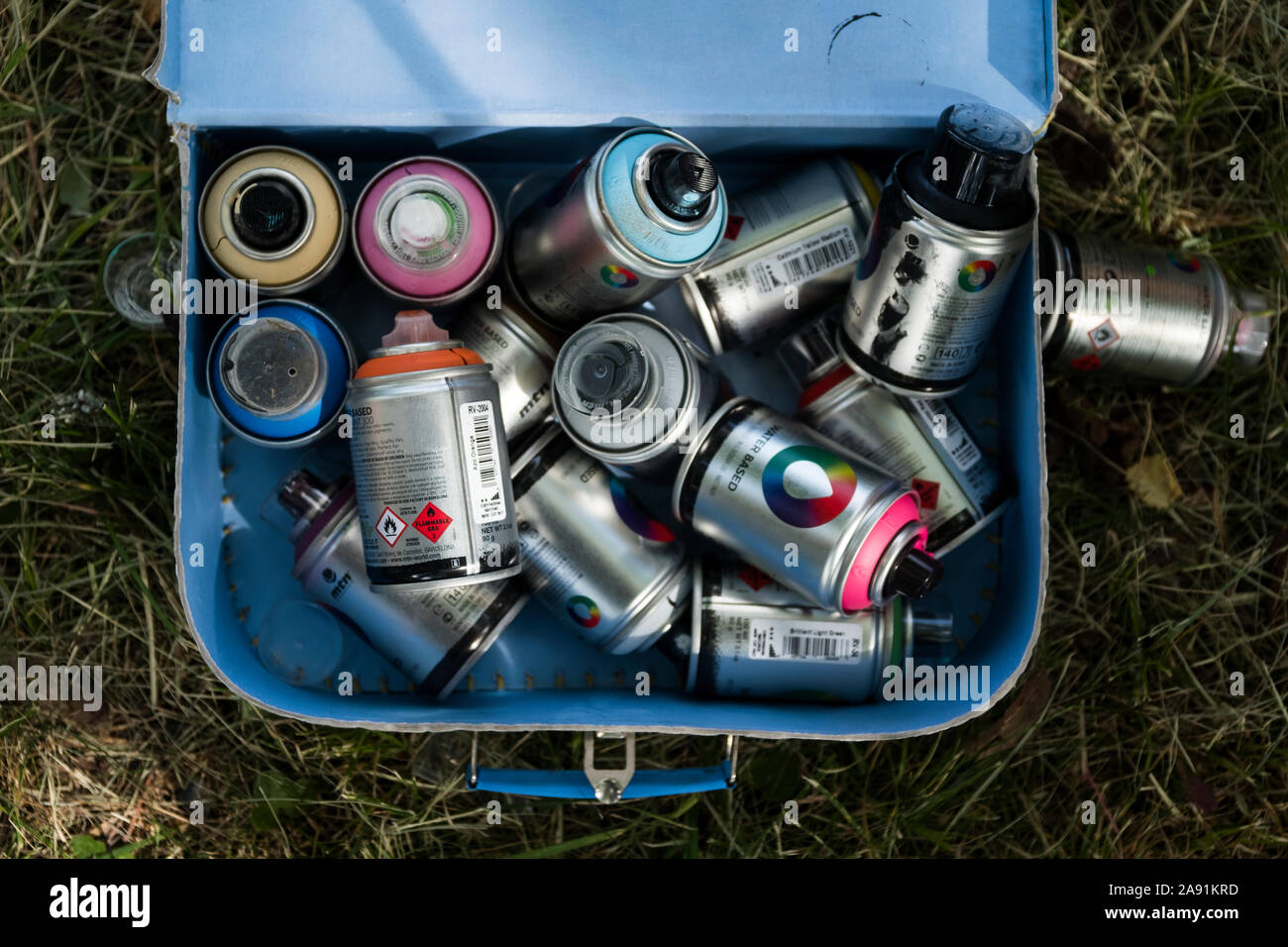 Spray paints in container Stock Photo - Alamy