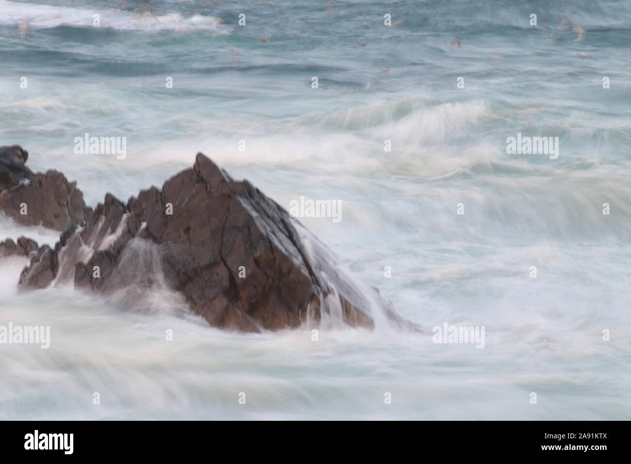 Rock and waves Stock Photo - Alamy