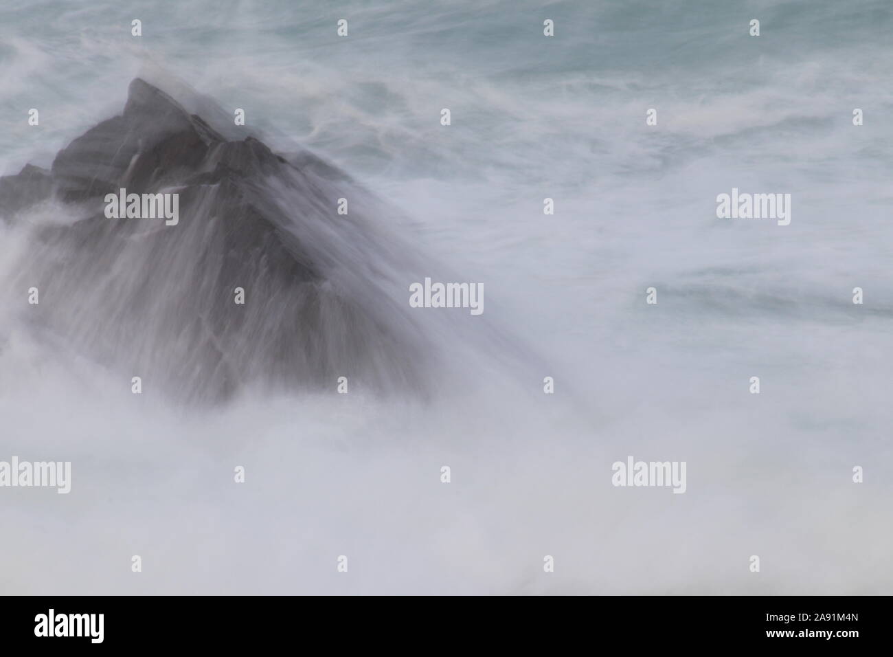 Rock and waves Stock Photo - Alamy