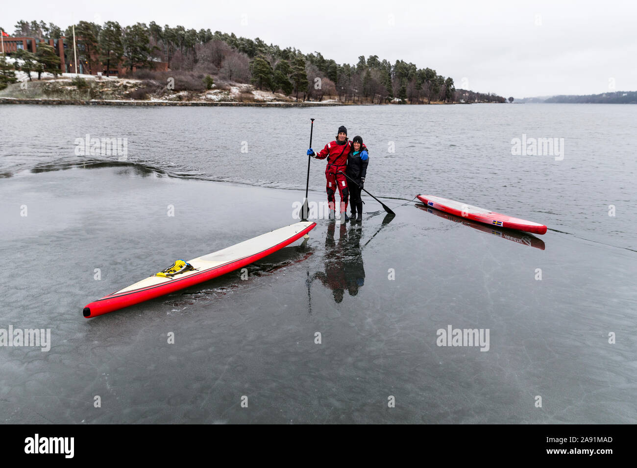 Man and woman paddle boarding Stock Photo - Alamy