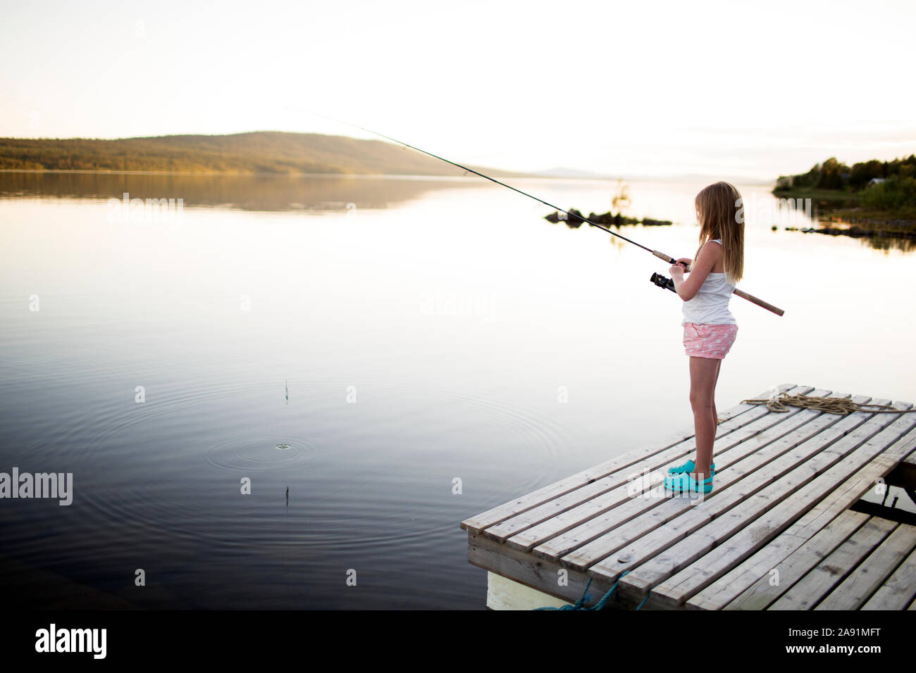 Girl fishing in lake Stock Photo - Alamy