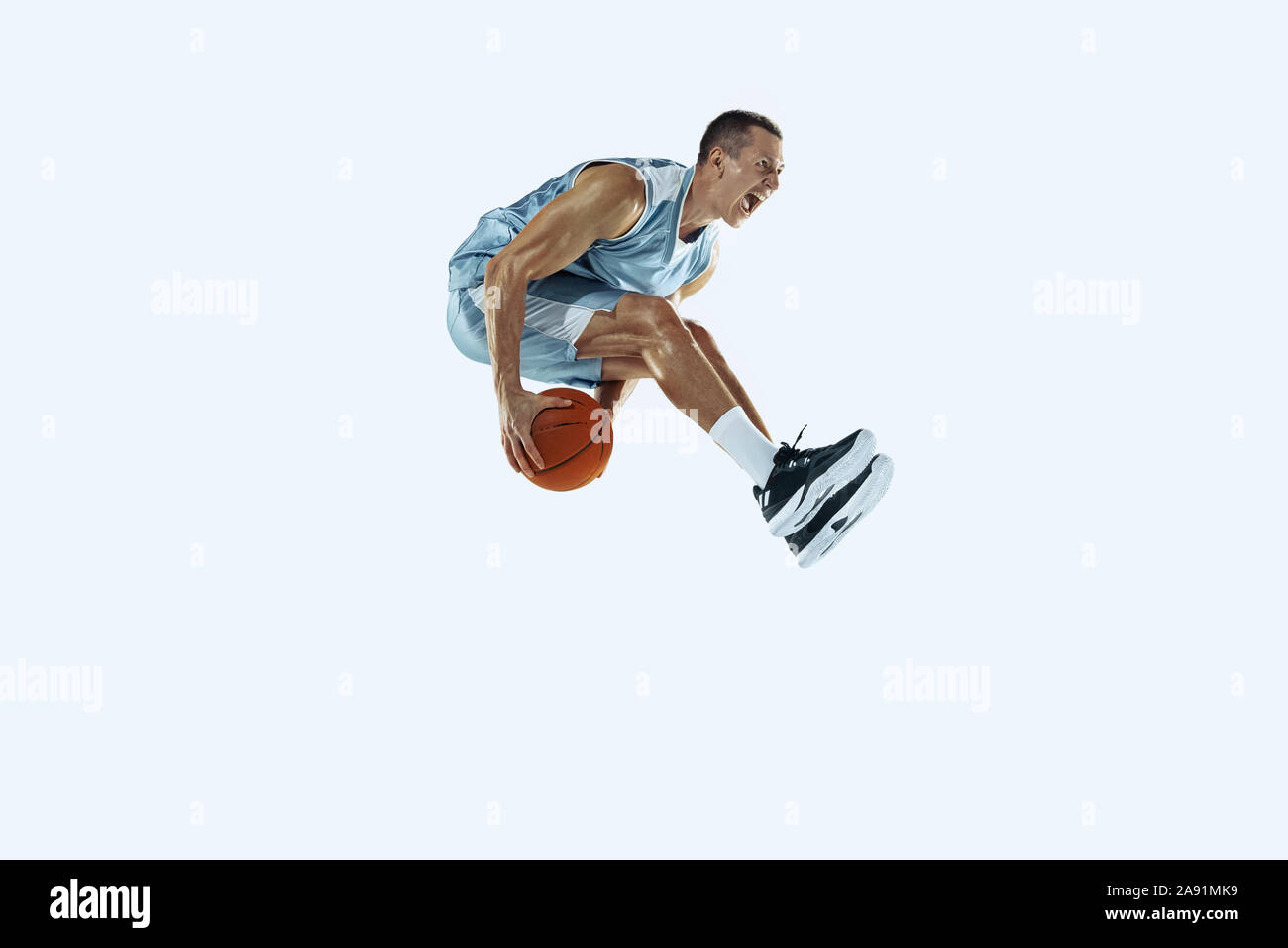 High flight. Young caucasian basketball player of team in action ...