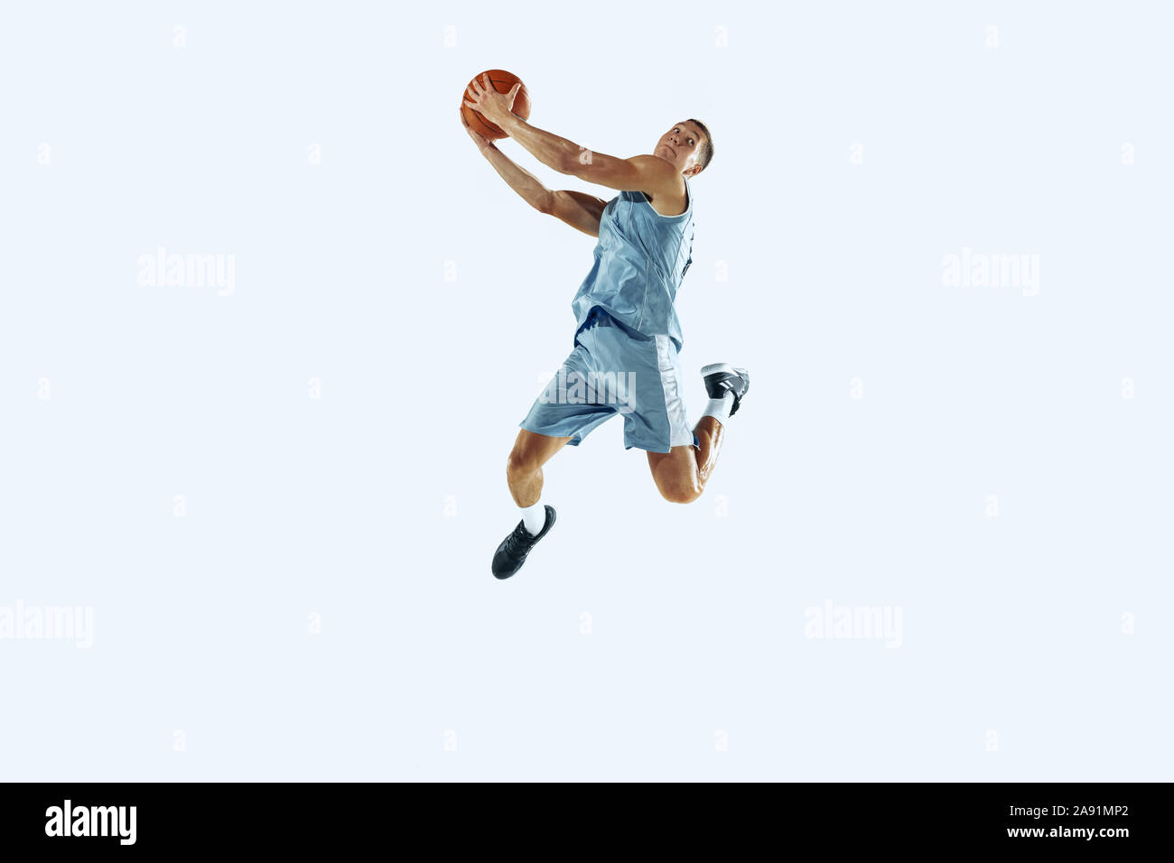 High flight. Young caucasian basketball player of team in action ...