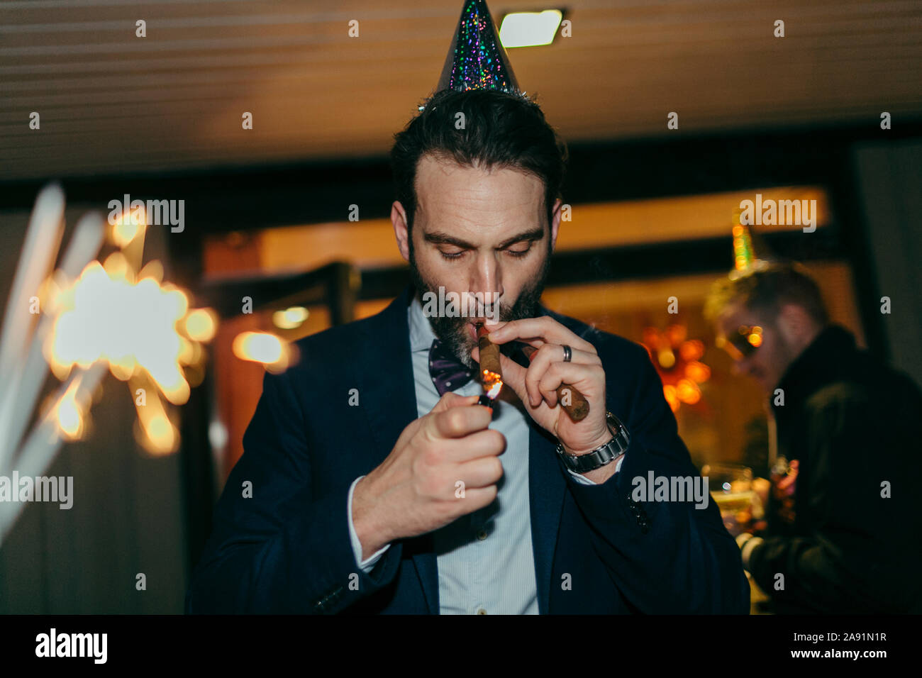 Man smoking cigar at party Stock Photo - Alamy