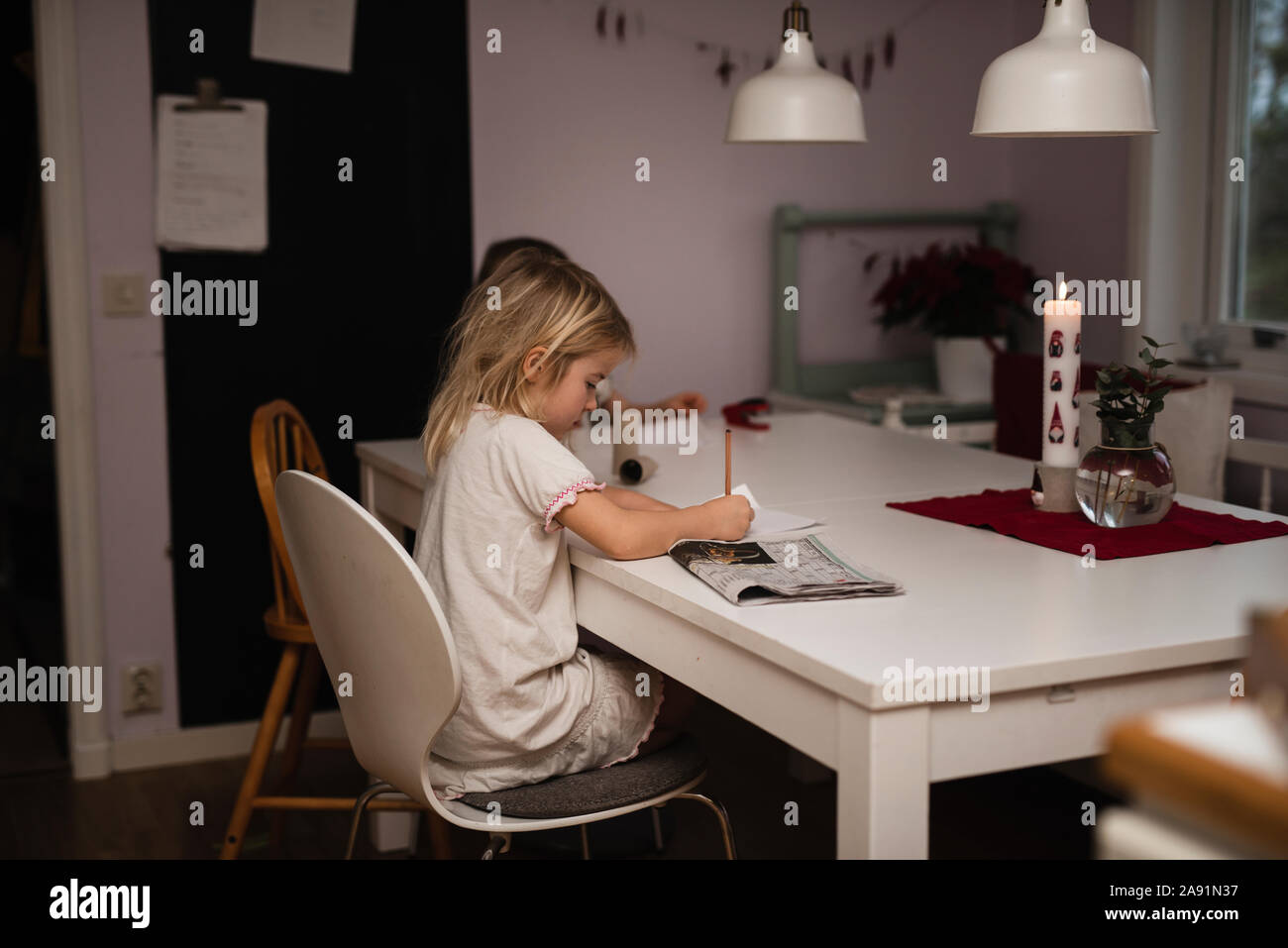 Girl sitting kitchen table writing hi-res stock photography and images ...