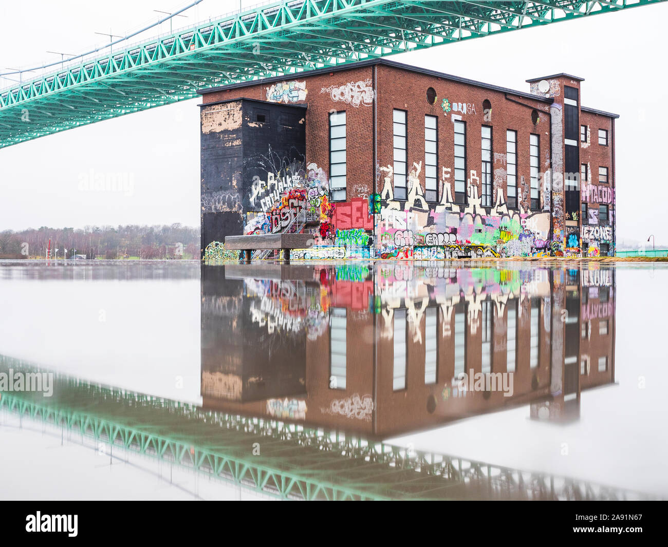 Building under suspension bridge Stock Photo - Alamy