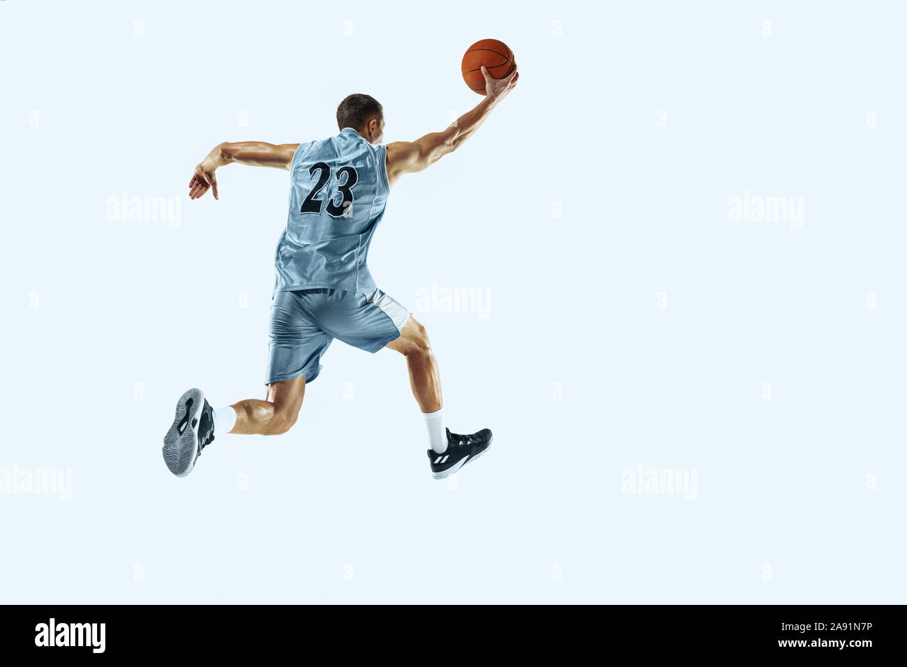 High flight. Young caucasian basketball player of team in action ...