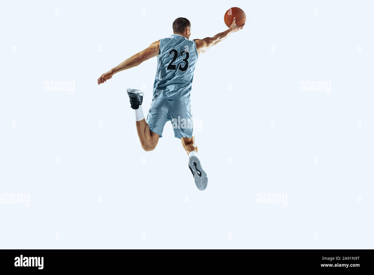 High flight. Young caucasian basketball player of team in action ...