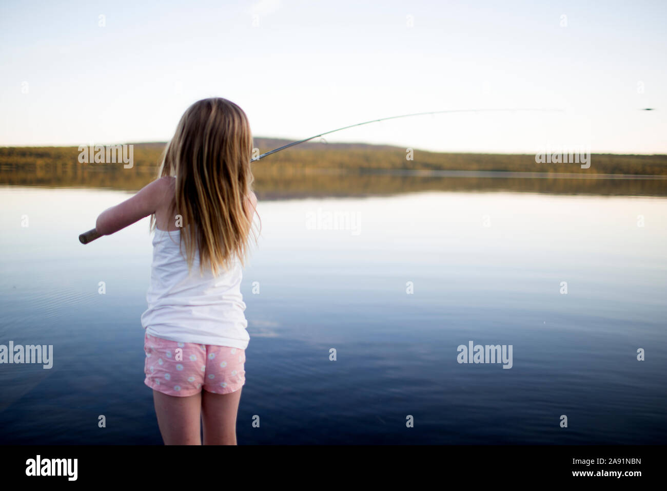 Girl fishing in lake Stock Photo - Alamy