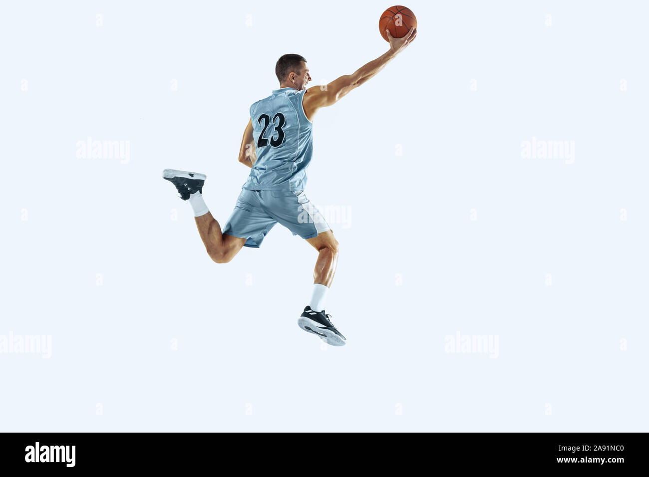 High flight. Young caucasian basketball player of team in action ...