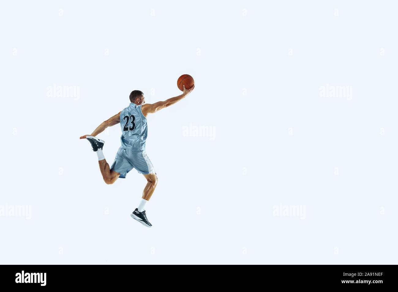 High flight. Young caucasian basketball player of team in action ...