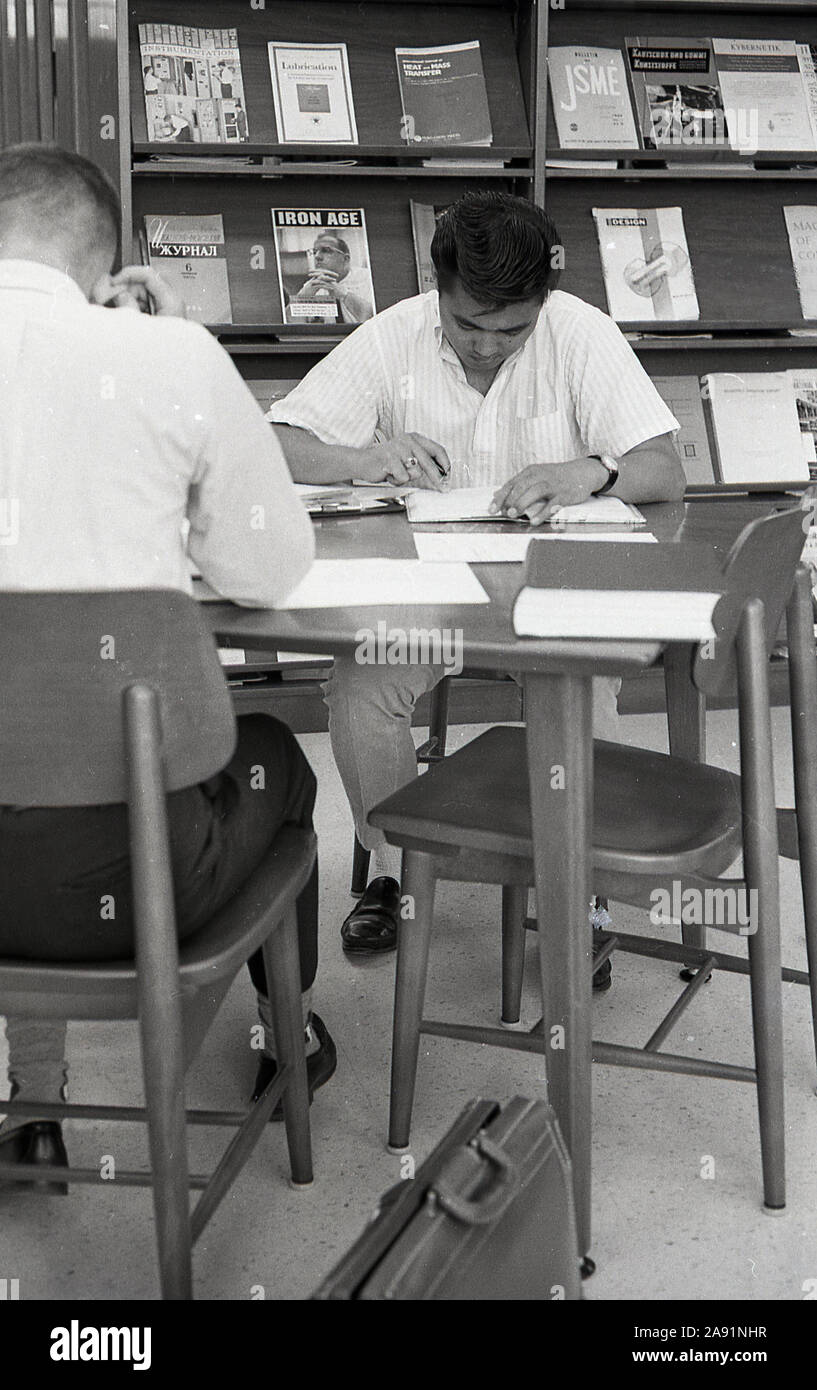 1960s, historical, male students sitting at a desk studying in a ...