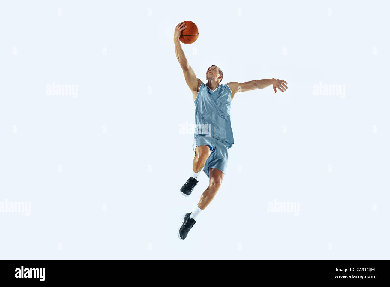 High flight. Young caucasian basketball player of team in action ...