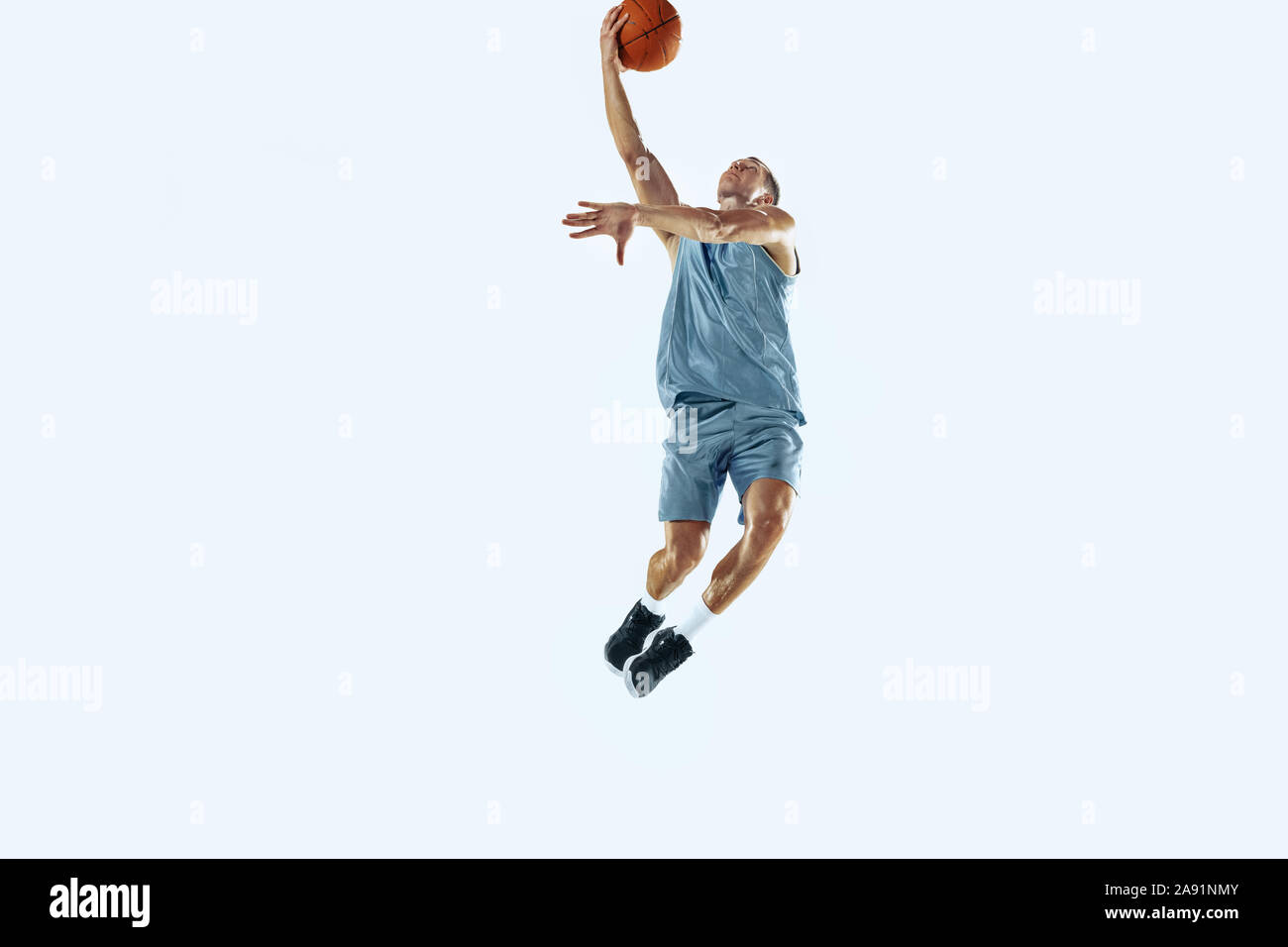 High flight. Young caucasian basketball player of team in action ...