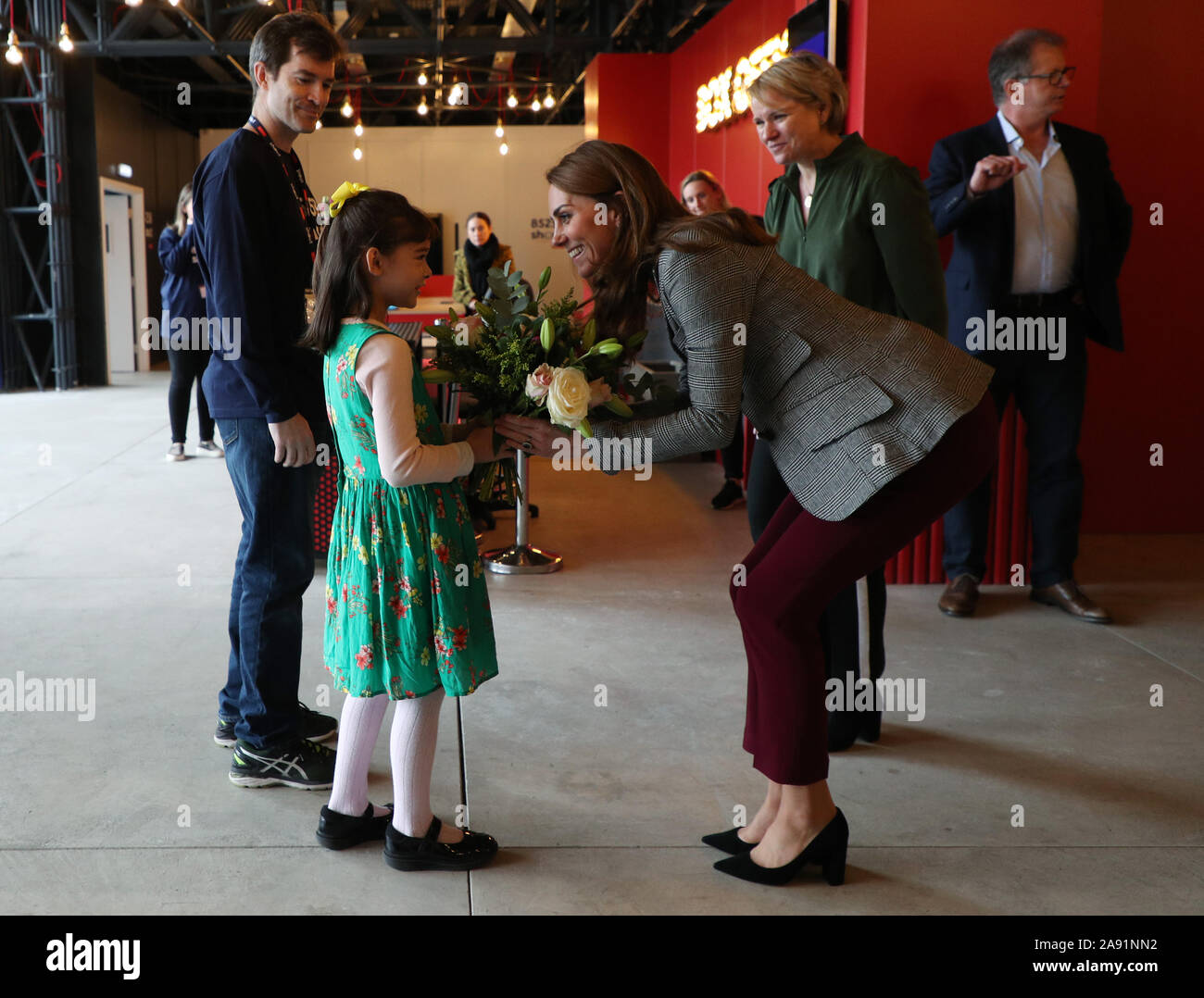 The Duchess of Cambridge is presented with flowers from Michaela Conway ...