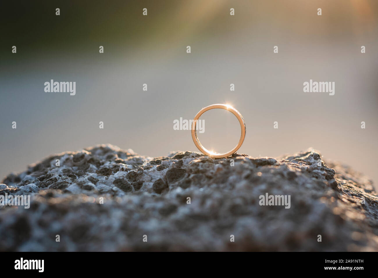 Wedding ring on rock Stock Photo - Alamy