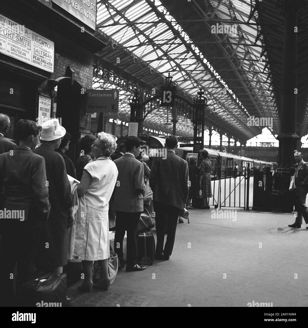 1960s, historical, Victorian railway station, rail passengers queuing ...