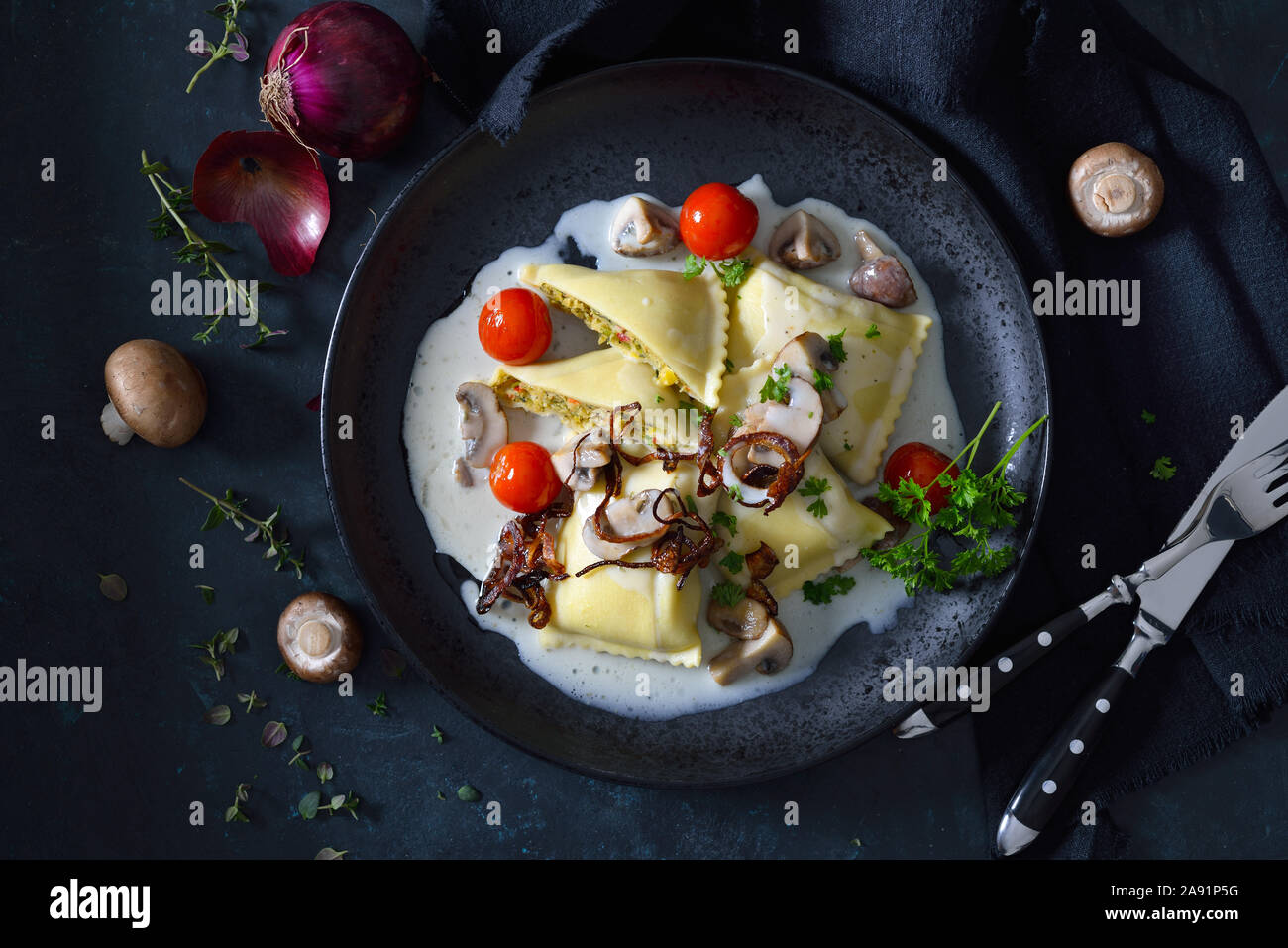 Swabian vegetable ravioli (so called 'Maultaschen') with mushroom cream ...