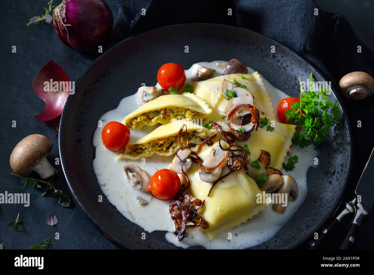 Swabian vegetable ravioli (so called 'Maultaschen') with mushroom cream ...