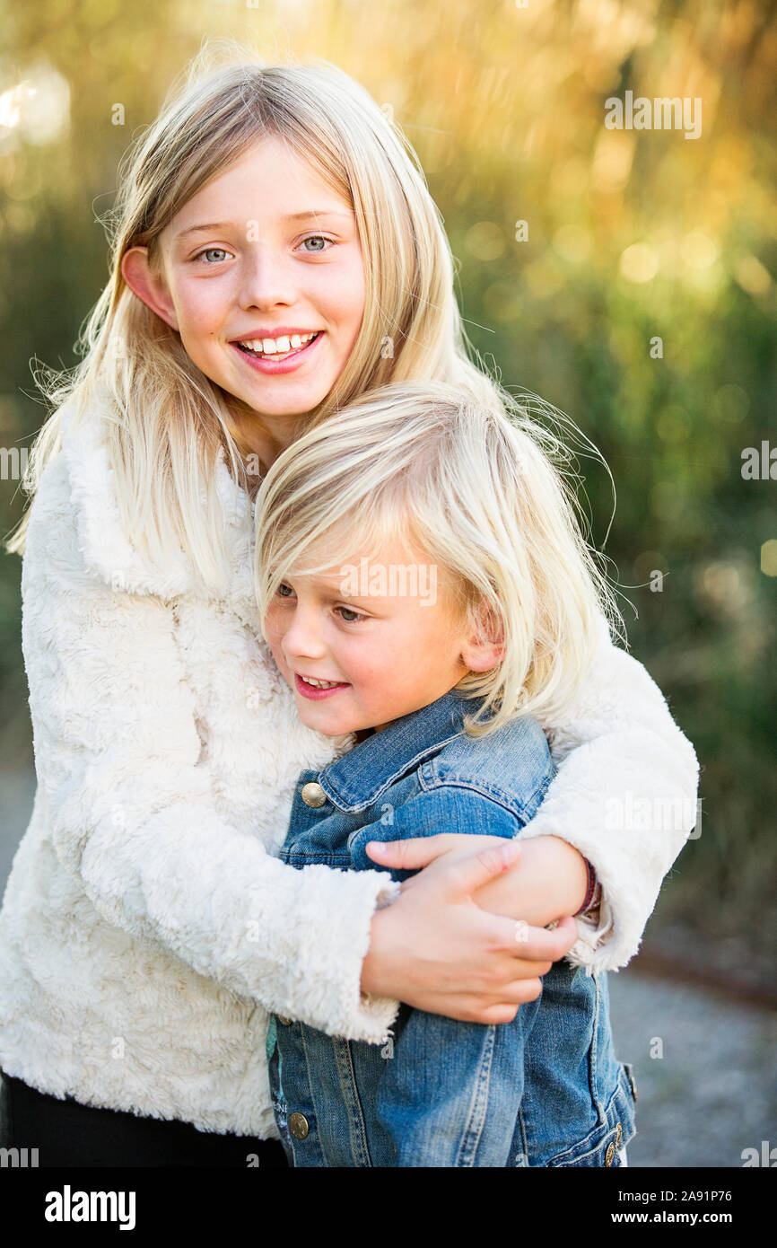 Brother and sister hugging Stock Photo - Alamy