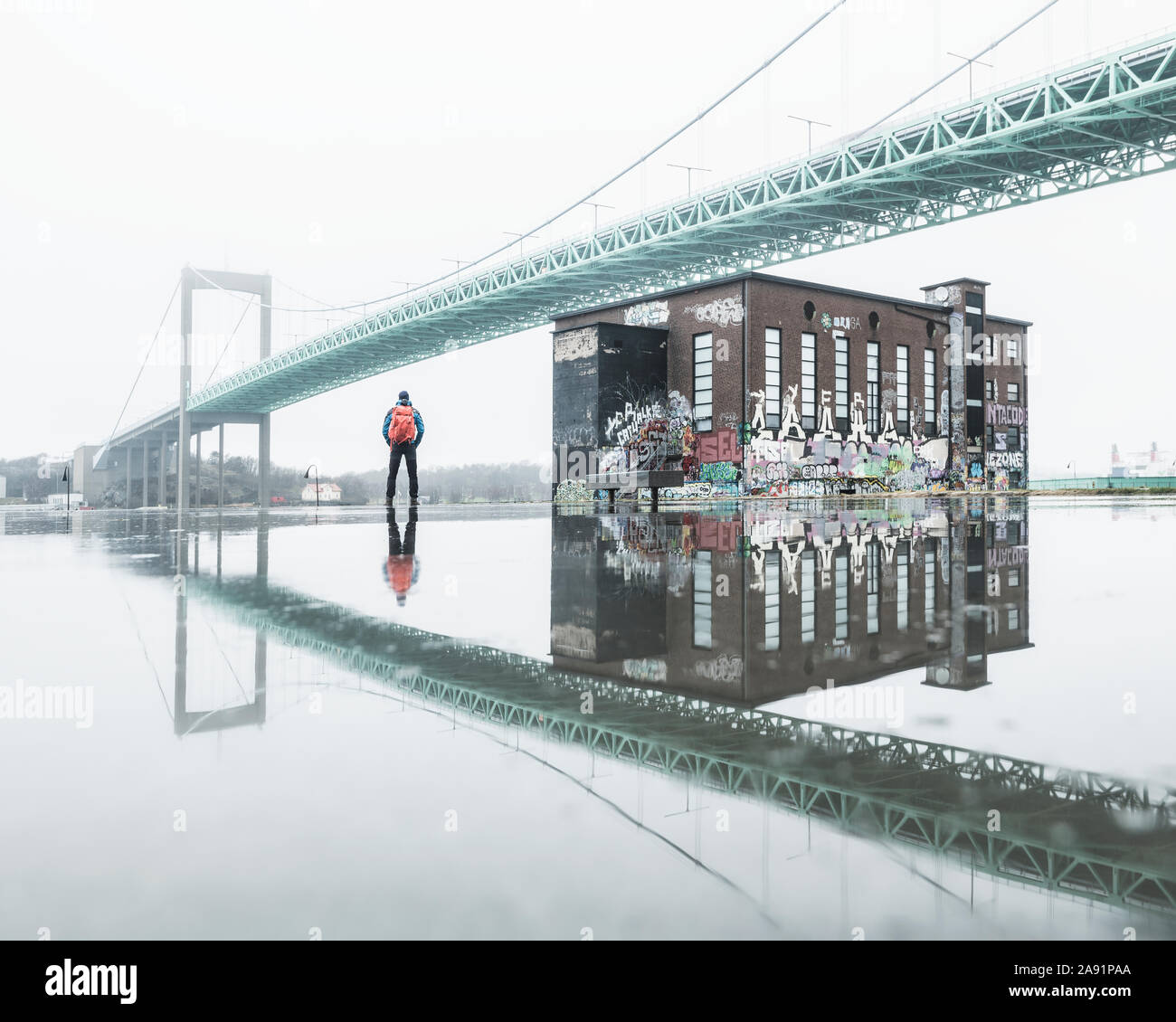 Building under suspension bridge Stock Photo - Alamy