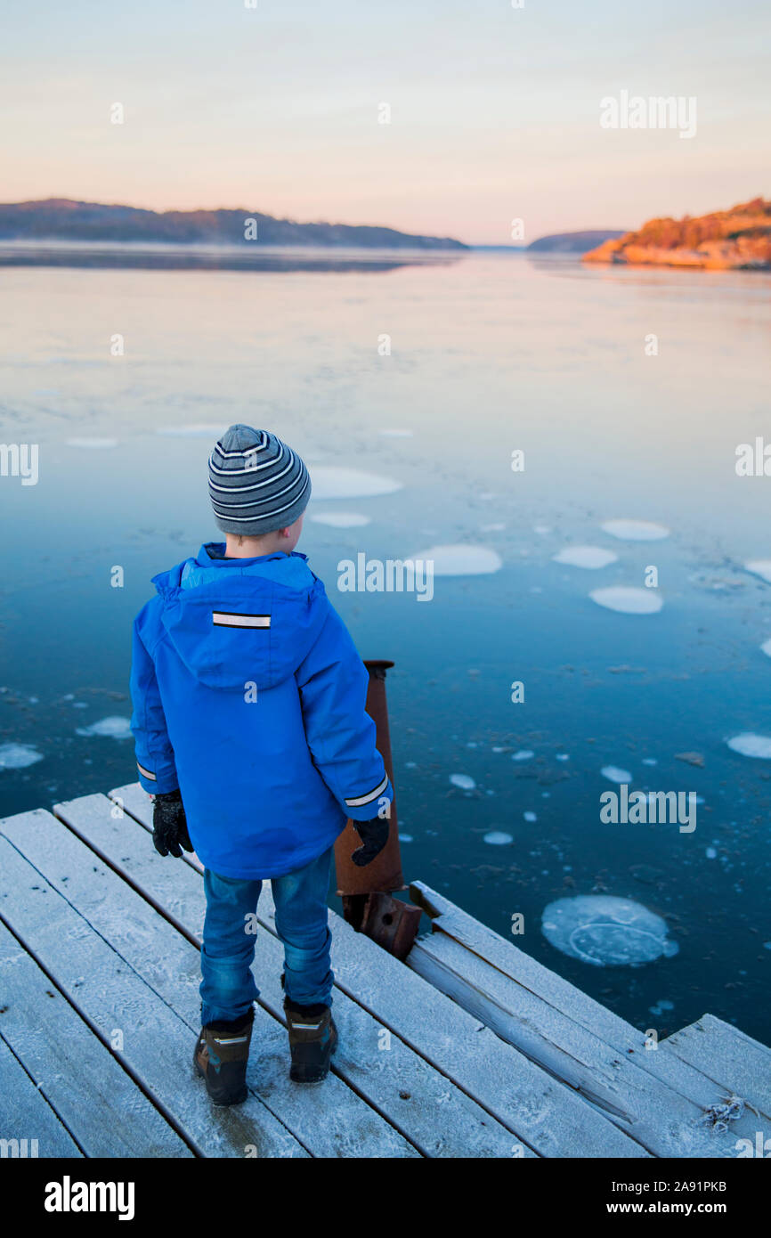 Boy on jetty Stock Photo - Alamy