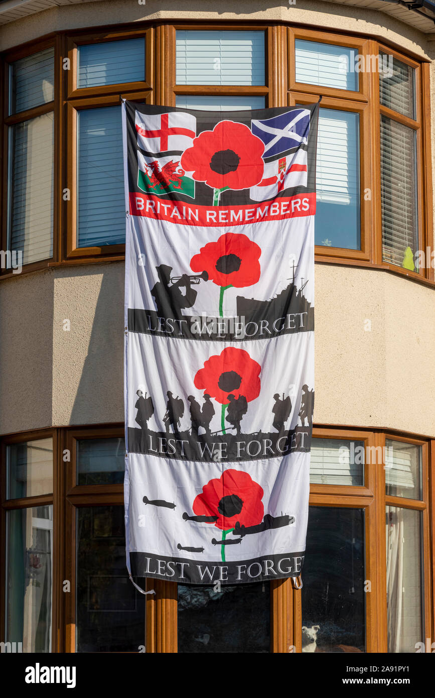 Large Lest we forget flag banner hanging from house on Remembrance ...