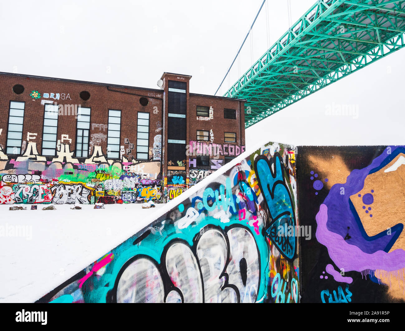 Building covered with graffiti under bridge Stock Photo - Alamy