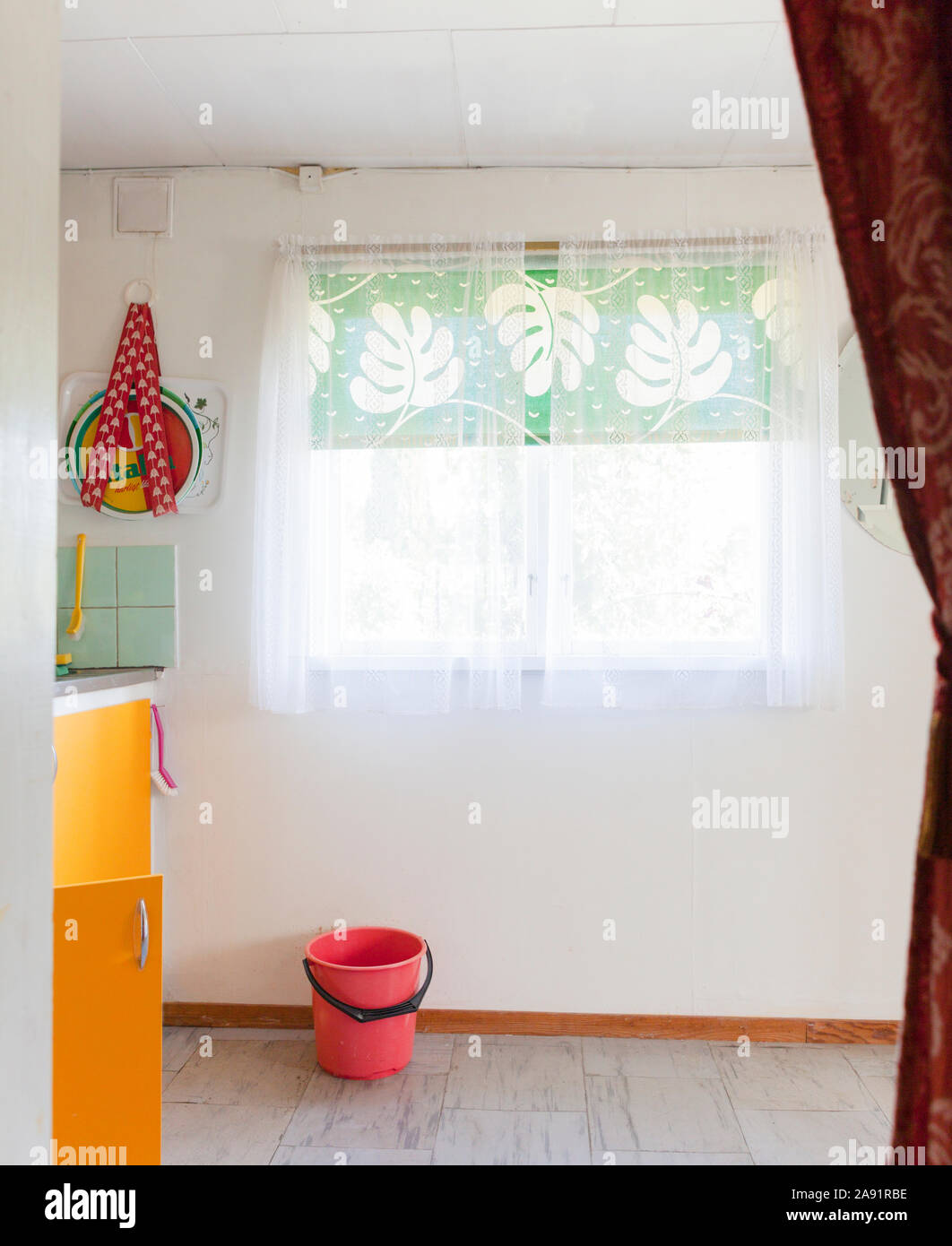 Bucket under kitchen window Stock Photo - Alamy