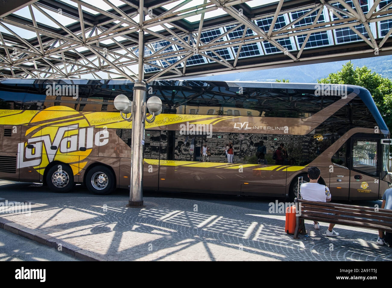 ITALY, AOSTA - JULY 8: Big coach is going under roof of the bus station ...
