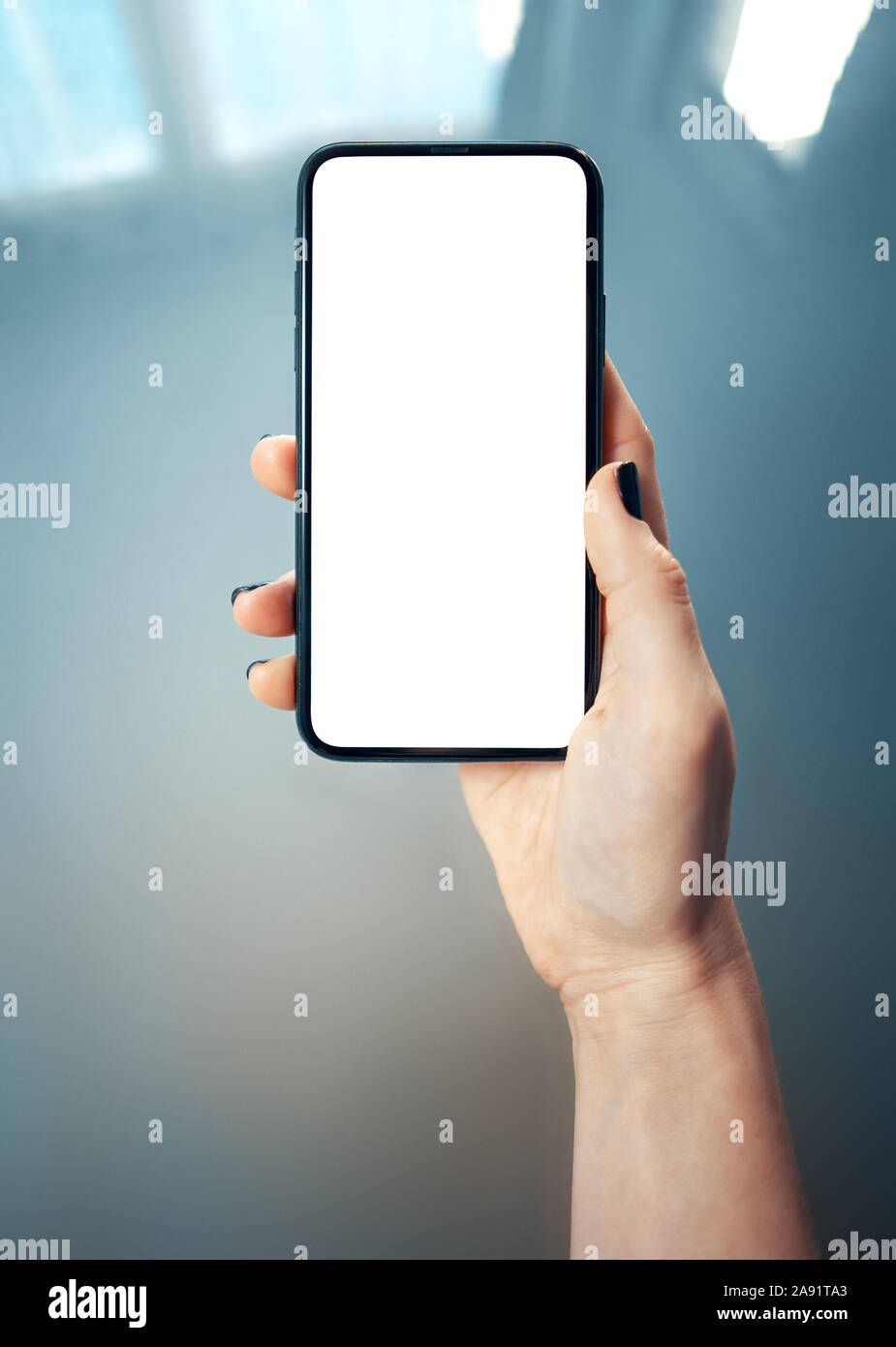 Mockup image of woman's hand holding thin bezels mobile phone with ...