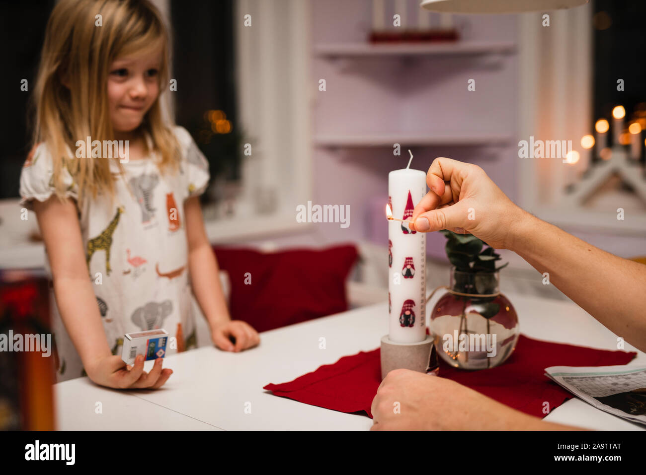 Hand lighting candle Stock Photo - Alamy