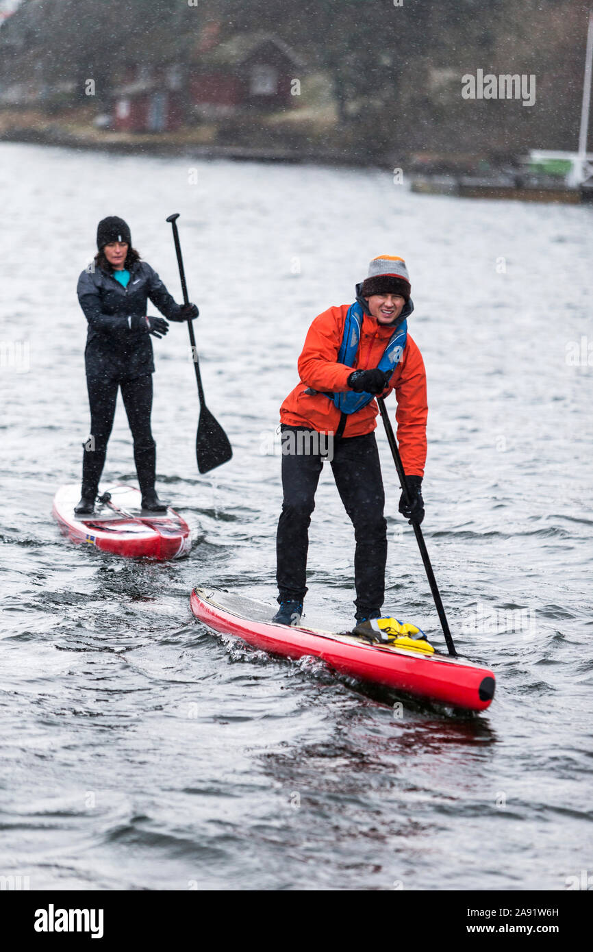 Man and woman paddle boarding Stock Photo - Alamy