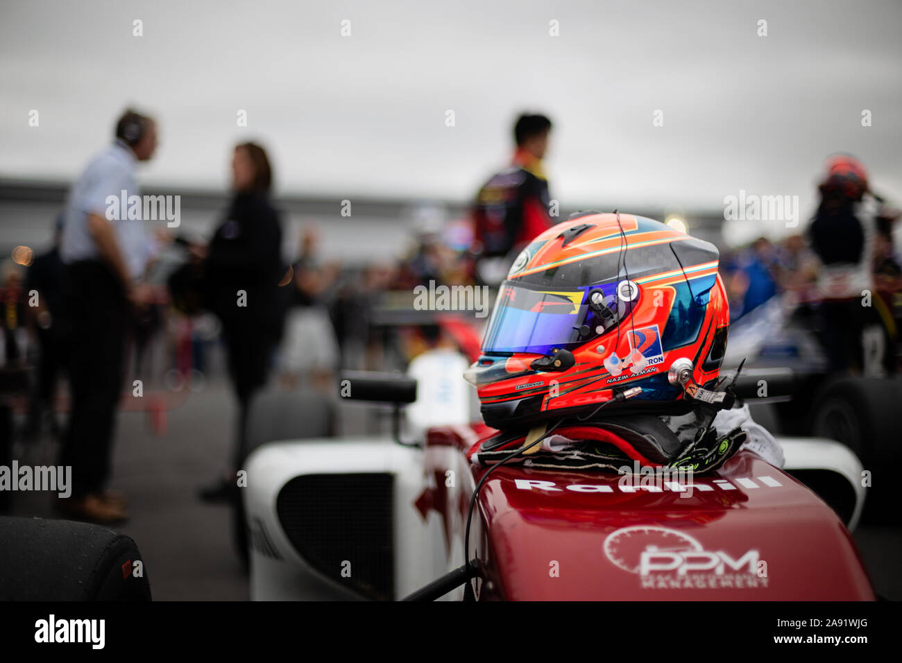 Race drivers helmet on top of race car after the race Stock Photo - Alamy