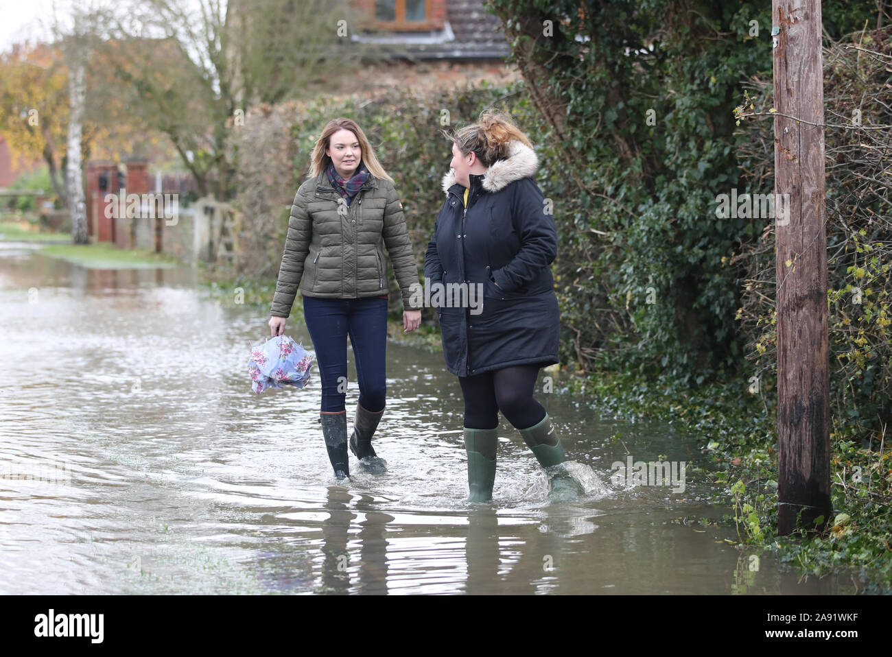 Residents walk through floodwater hi-res stock photography and images ...