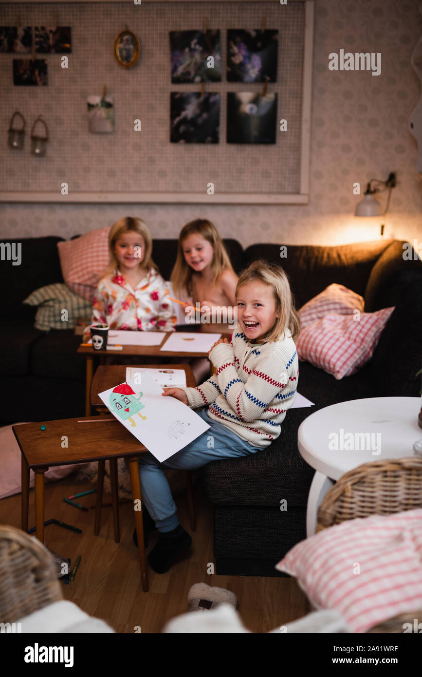 Smiling girls drawing together Stock Photo - Alamy