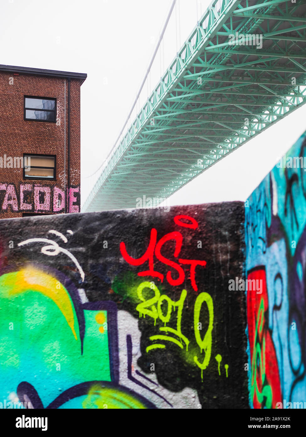 Graffiti, suspension bridge on background Stock Photo - Alamy