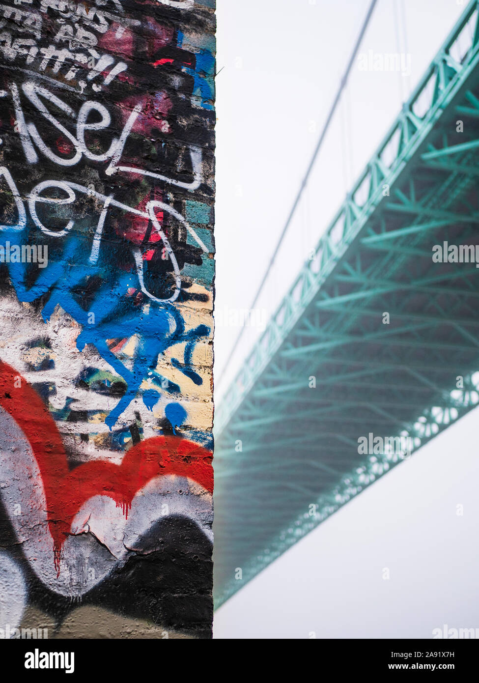 Graffiti, suspension bridge on background Stock Photo - Alamy