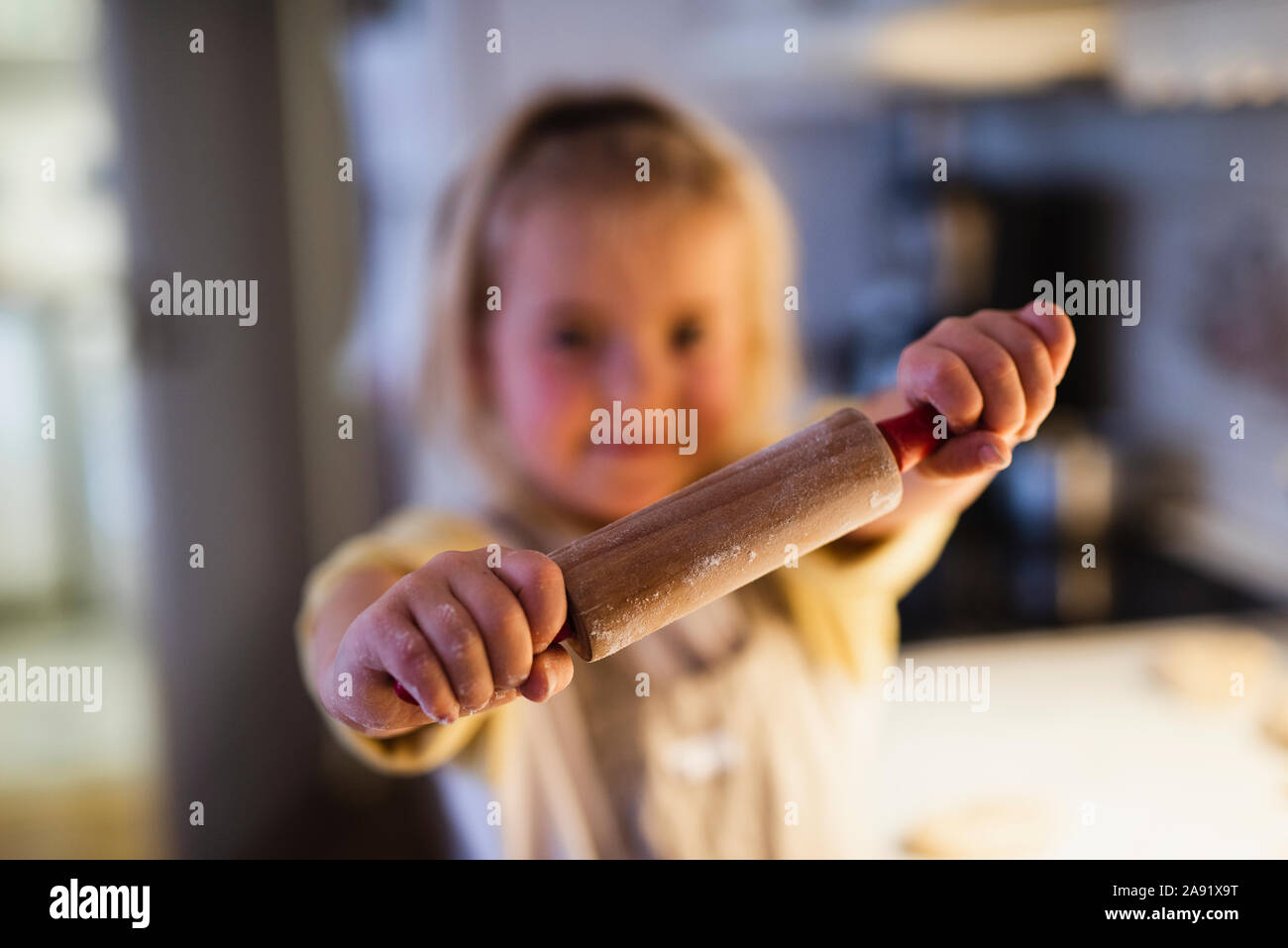 Girl holding rolling pin Stock Photo - Alamy