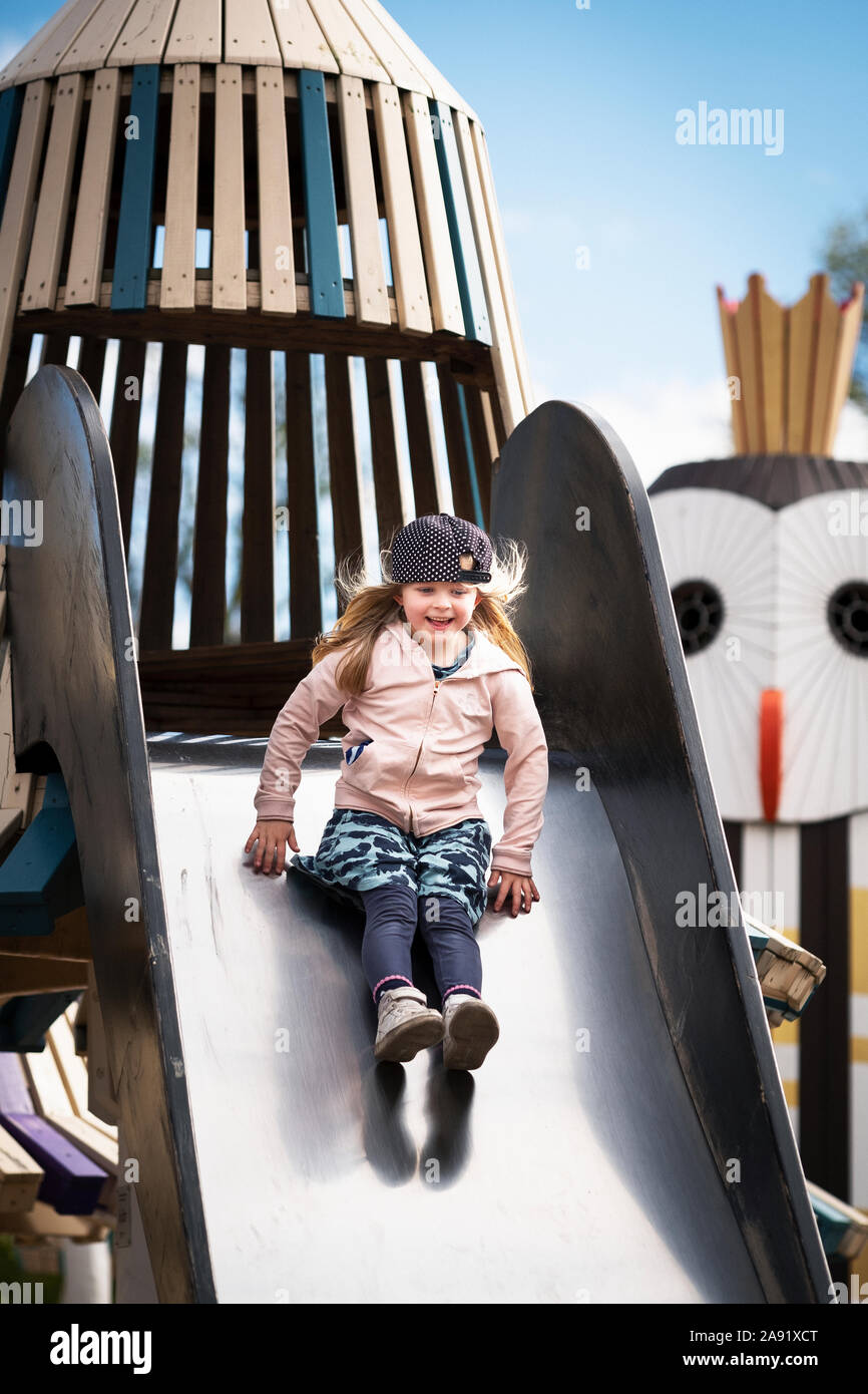 Smiling girl on slide Stock Photo - Alamy