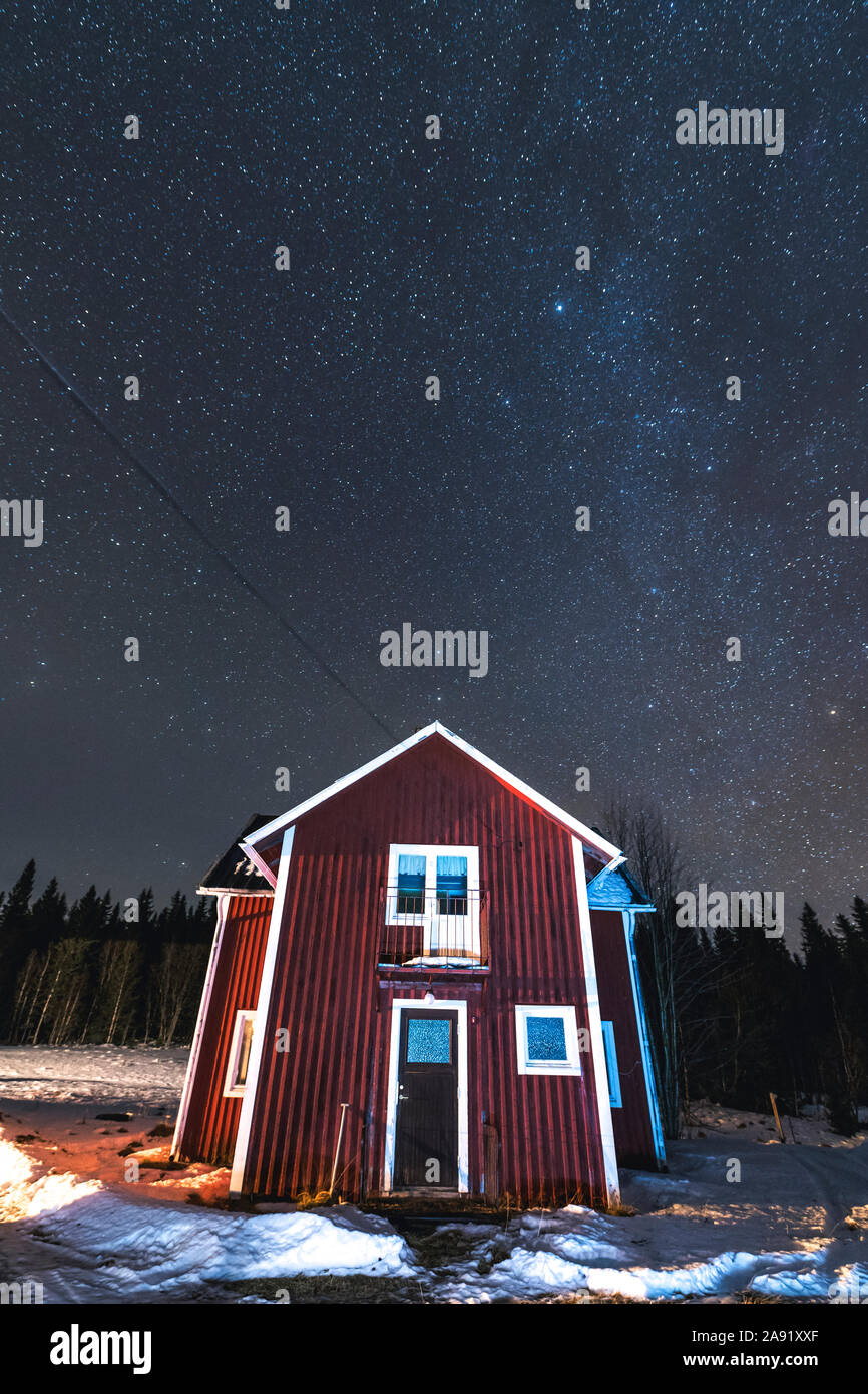 Wooden house at winter night Stock Photo - Alamy